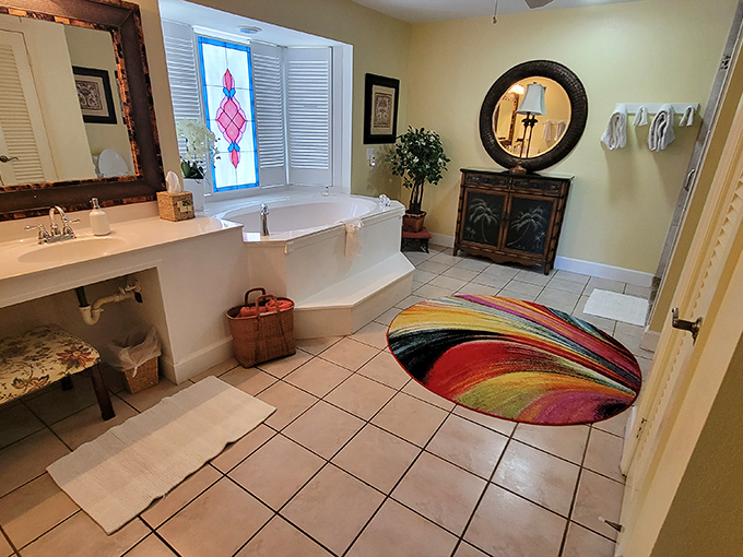 Bathroom luxury that makes you reconsider your morning routine: Soaking tub, stained glass, and enough space to practice your acceptance speech for "Best Relaxed Person."
