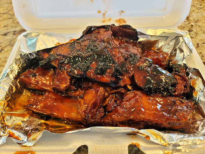 Meat candy. These ribs have spent so much time in the smoker they've practically earned tenure. The bark on that exterior is textbook perfection.