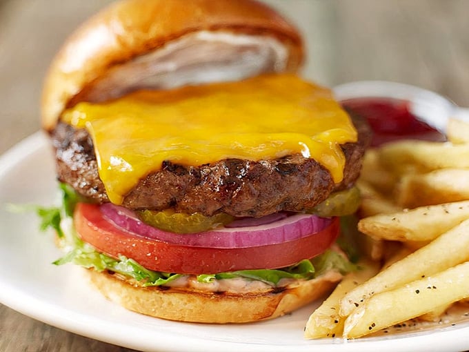 A burger that doesn't need fancy aioli or artisanal buns to make its point—just honest ingredients stacked with architectural precision.