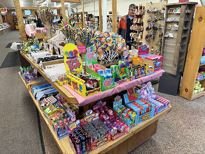 Lollipops standing tall like a colorful forest of sugar trees. This display could make even Willy Wonka pause in admiration.