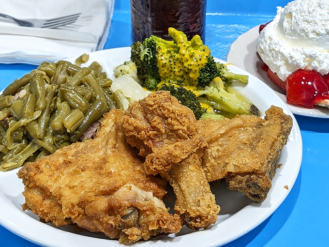 The trifecta of comfort: golden chicken, green beans with personality, and a slice of cherry pie waiting in the wings.