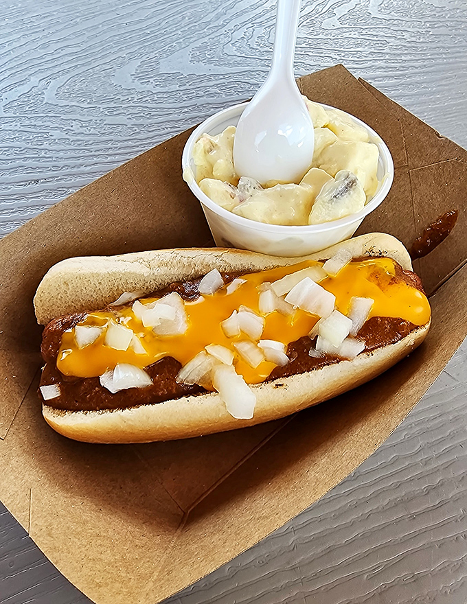 The Detroit-style coney in its natural habitat&mdash;smothered in chili, draped with melted cheese, and sprinkled with diced onions. A beautiful mess worth every napkin.