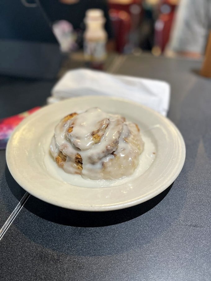 This cinnamon roll isn't just pastry &ndash; it's a spiral-shaped argument against skipping breakfast, glistening with icing.