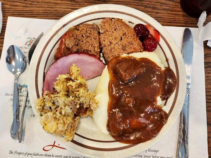 The plate that launched a thousand "I'll start my diet tomorrow" promises. Meatloaf, ham, stuffing, and gravy-smothered potatoes—a masterclass in comfort.