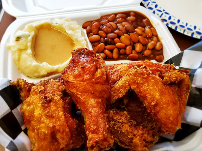 This isn't just fried chicken&mdash;it's edible artwork with a side of mashed potatoes and baked beans. A masterpiece you can eat with your hands.