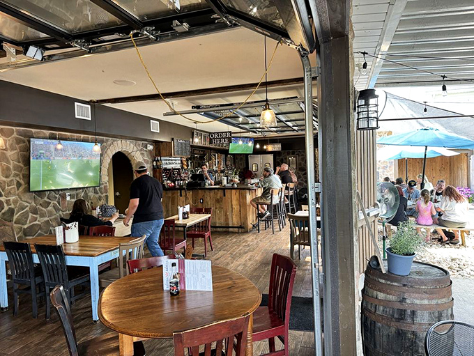 The dining room buzzes with that perfect pub energy—part community gathering, part culinary adventure, all wrapped in wood and stone.