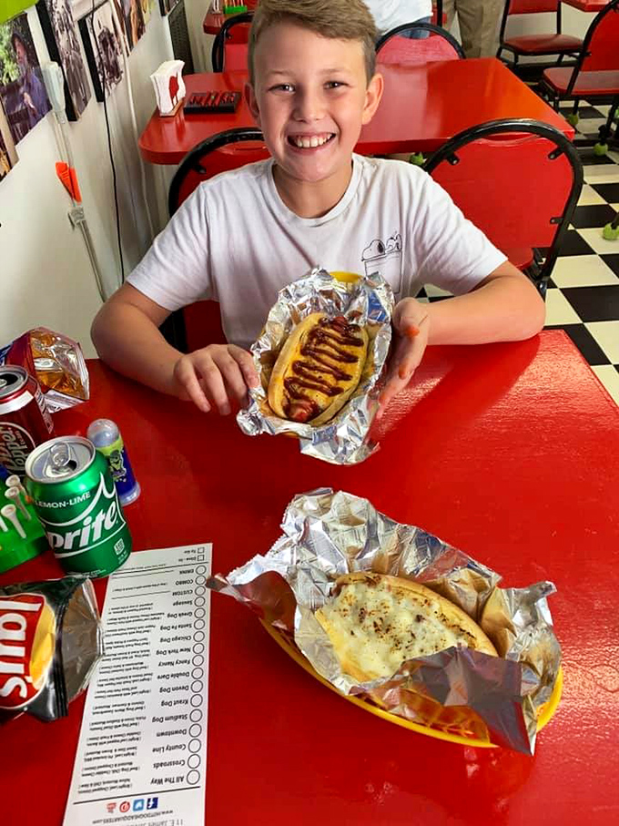 The restaurant may not offer table service, but it delivers smiles with every order. The hot dog in the foreground tells the whole story.