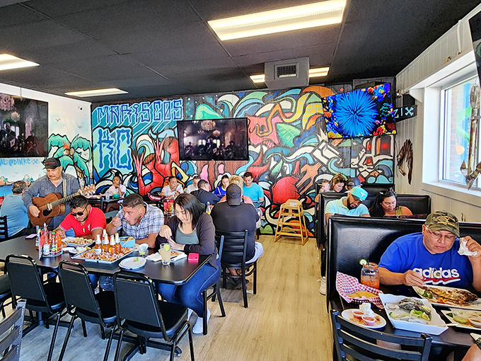 A full house of happy diners proves the point: great seafood creates community, even in the most unexpected locations. The murals provide the perfect backdrop.