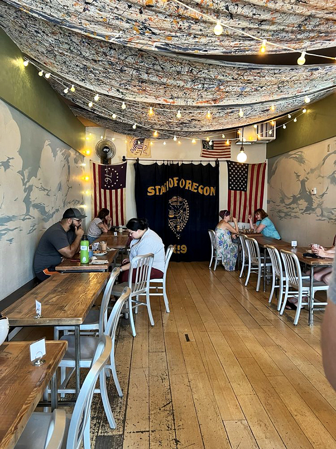 The dining area embodies Portland's unique charm with string lights, wooden tables, and state flags creating a cozy community space for donut enthusiasts.