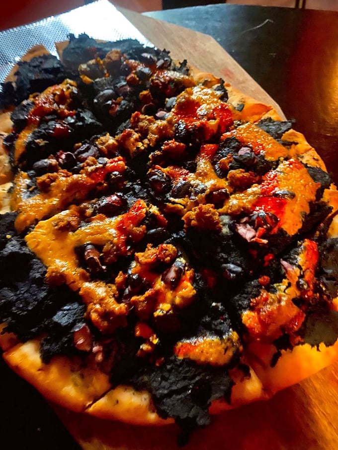 Elegant chandeliers wrapped in ghostly webs cast the perfect glow for contemplating life, death, and what cocktail to order next. 