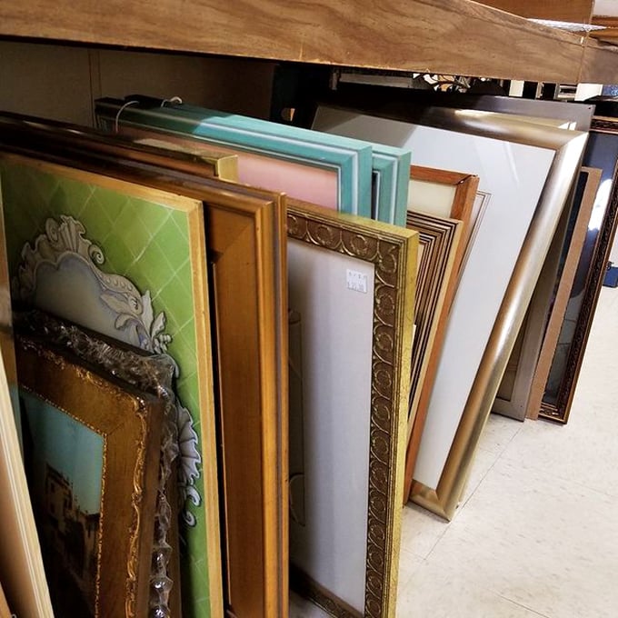 Picture frames waiting for their next family portrait. That ornate gold one definitely hung in someone's formal living room.