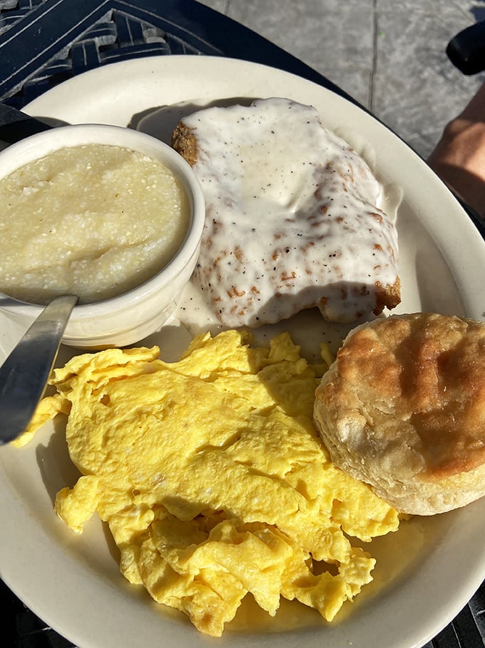 Breakfast perfection: golden scrambled eggs, country fried steak, grits, and a biscuit. The kind of plate that makes you understand why breakfast is the most important meal.