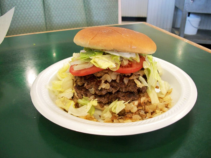 The onion-fried burger in its natural habitat &ndash; a simple white plate. Those caramelized onions aren't just toppings, they're transformation.