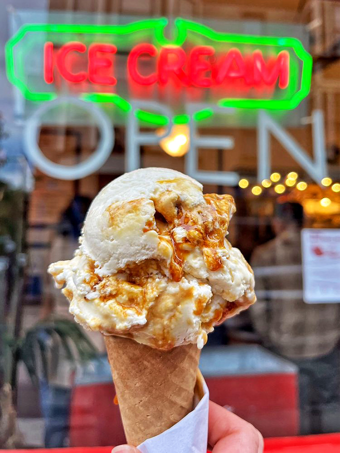 That ice cream cone isn't just showing off&mdash;it's posing in front of its birthplace, letting the neon glow highlight its perfect swirl and texture. 