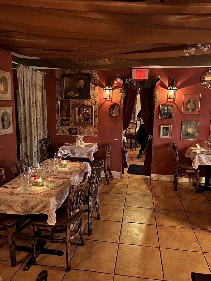 The warm glow of lantern light against crimson walls creates the kind of ambiance where even ordering water feels like a special occasion.