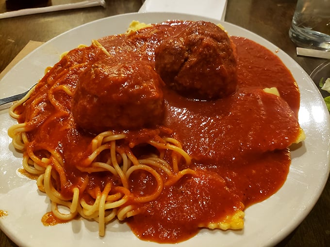 The sauce-to-pasta ratio achieves mathematical perfection, with meatballs standing like edible monuments to Italian-American ingenuity.
