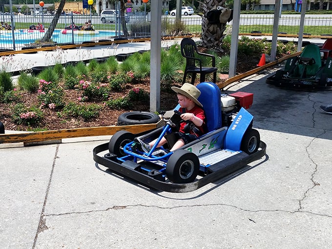 Future NASCAR champion or just enjoying the freedom of controlled speed? Either way, that determined face says everything about why we never outgrow the thrill of driving fast.