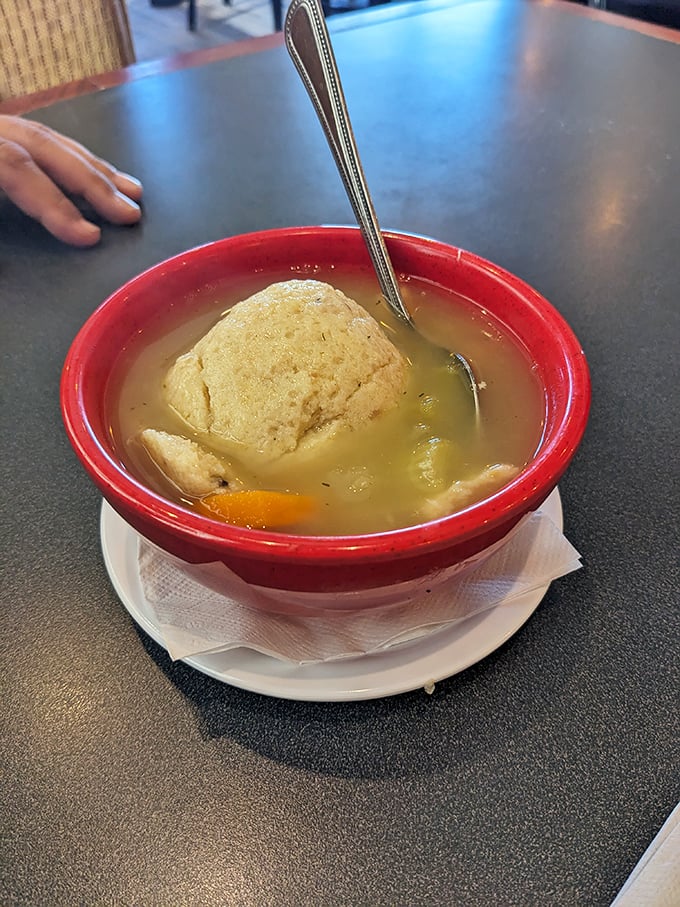 That matzo ball isn't floating&mdash;it's holding court. The spoon stands at attention, ready for the first transformative sip of Jewish penicillin.
