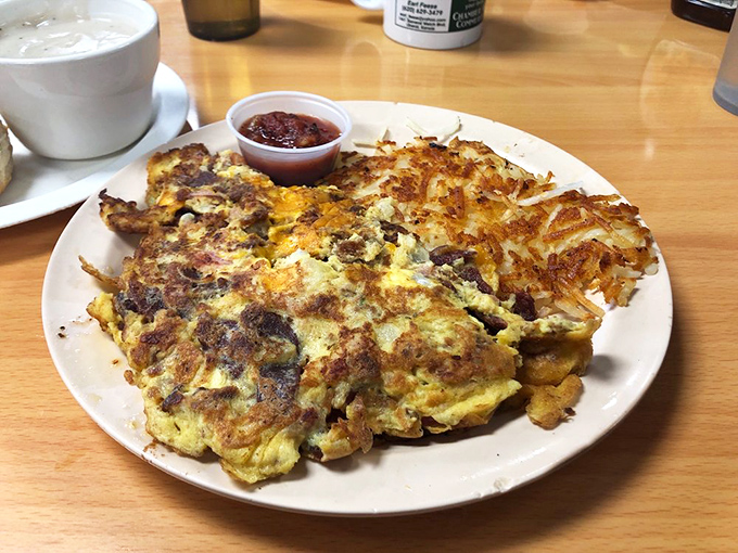 This omelet sprawls across the plate like it's claiming new territory &ndash; a manifest destiny of eggs, meat, and cheese that demands to be conquered.