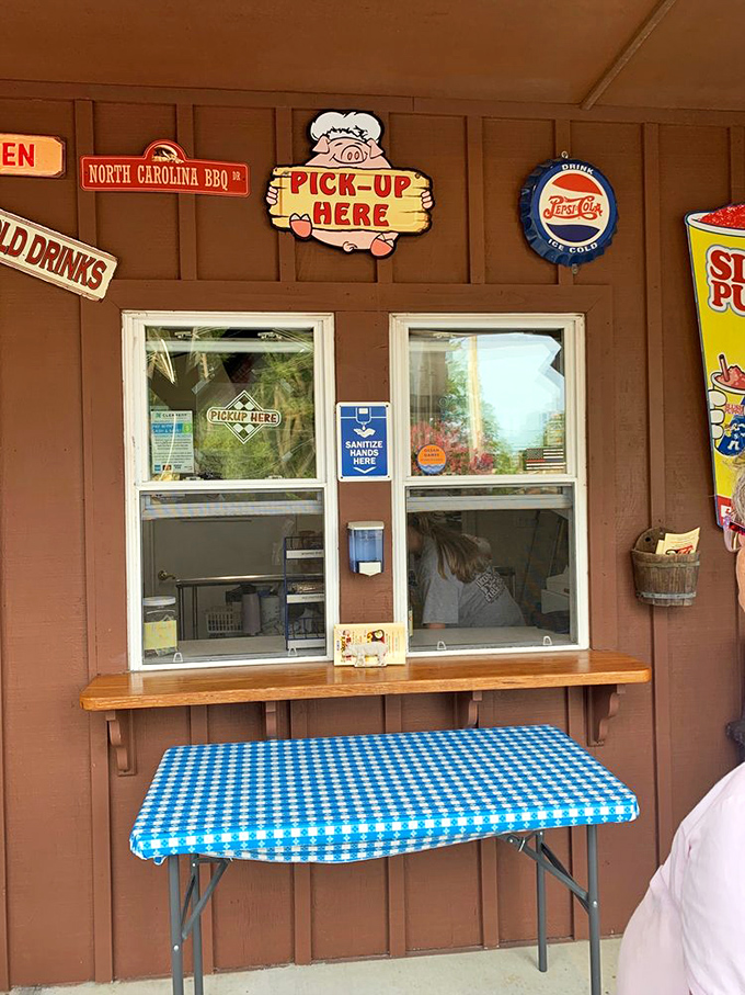 The pickup window—barbecue's version of a drive-through pearly gate. That "North Carolina BBQ" sign hints at the smoky treasures awaiting inside.