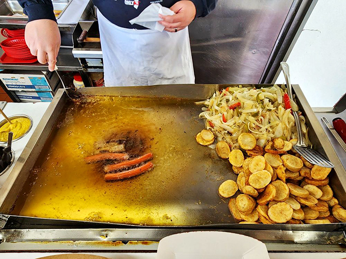Where the magic happens&mdash;hot dogs swimming in golden oil while potatoes and peppers wait their turn to join the party.