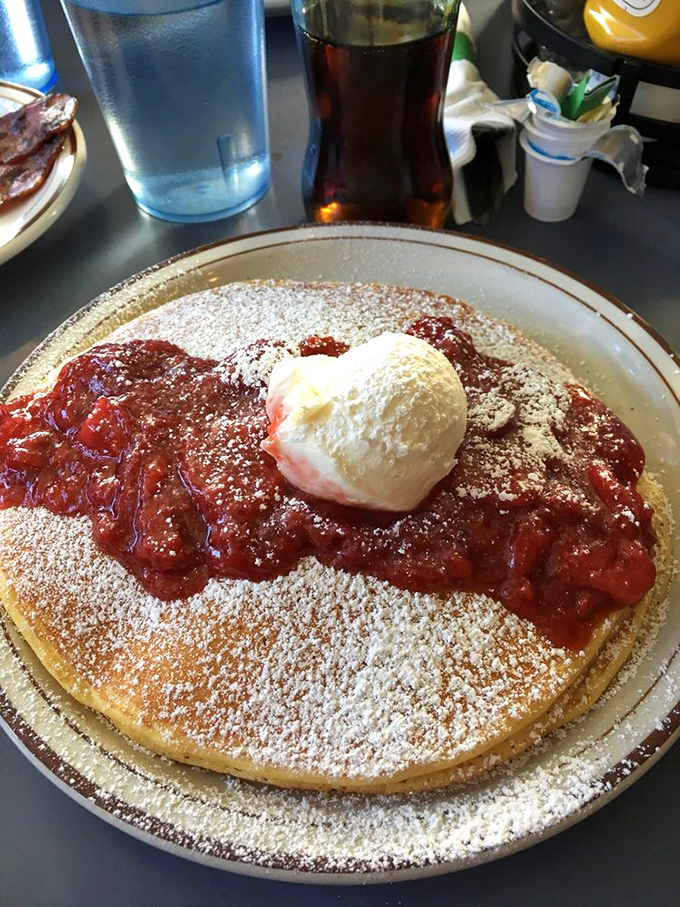 This isn't just a pancake&mdash;it's a sweet canvas topped with homemade strawberry sauce and a scoop of ice cream that makes breakfast feel gloriously rebellious.