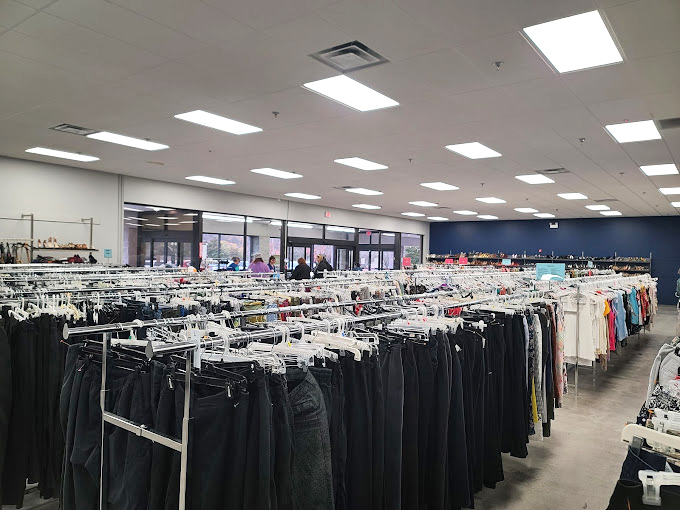 The men's section stretches into the distance like a sea of potential wardrobe upgrades, where designer labels hide among everyday basics.