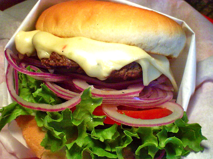 Fresh lettuce, vibrant red onions, and melted cheese create a color palette that food photographers dream about, but hungry customers don't wait to appreciate. 