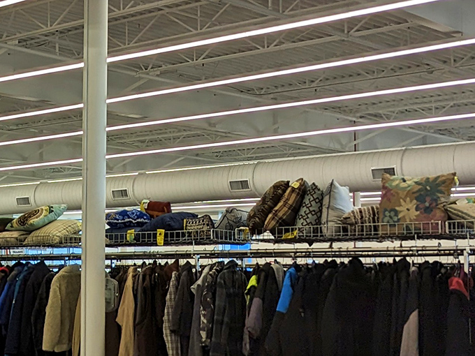 The pillow and bedding section floats above the clothing racks like textile clouds. Patterns from every decade wait to adorn your sofa.