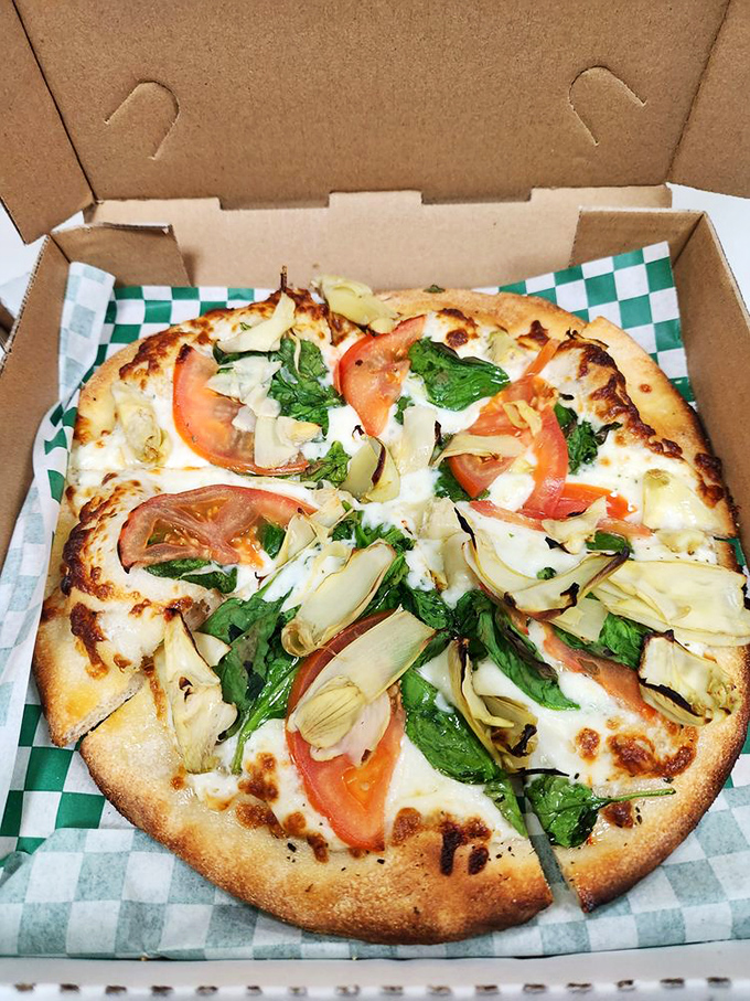 Pizza that knows exactly what it's doing&mdash;crisp crust, fresh tomatoes, artichokes, and spinach creating a garden of delights in every bite.