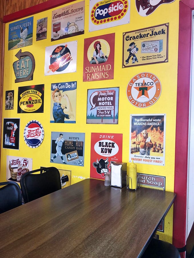 Wall of nostalgia &ndash; vintage advertisements create the perfect backdrop for conversations about simpler times and good food.