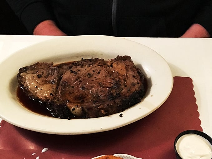 Prime rib swimming in its natural habitat of savory au jus. This isn't dinner—it's a religious experience with table service.