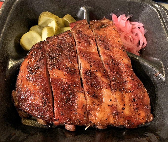 Ribs with a smoke ring so perfect it could be measured by NASA, accompanied by the traditional pink pickled onions and cucumber slices.