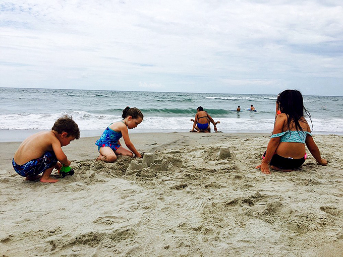 The universal truth of childhood: any beach becomes an architectural opportunity. These sandcastle engineers are just getting started.