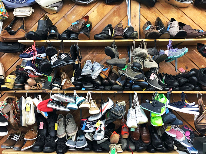 The shoe wall: a footwear archaeological dig where vintage Oxfords neighbor barely-worn sneakers, all waiting for their second dance.