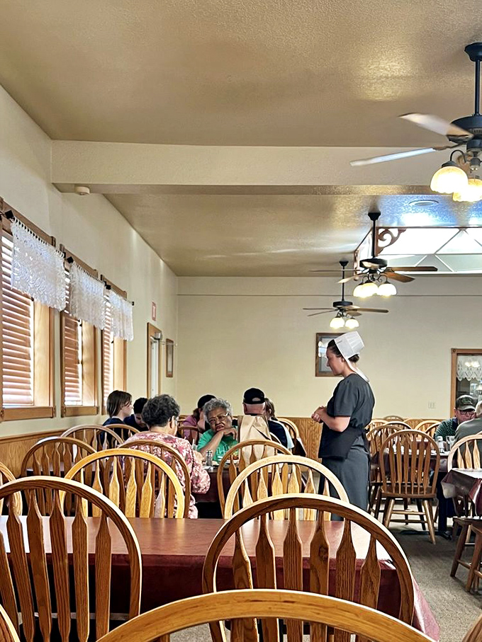 Servers in traditional dress add to the authentic experience, moving efficiently between tables with the confidence that comes from serving genuinely good food.