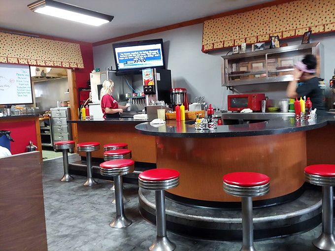 The curved counter with its classic red stools offers front-row seats to the choreographed dance of short-order cooking.