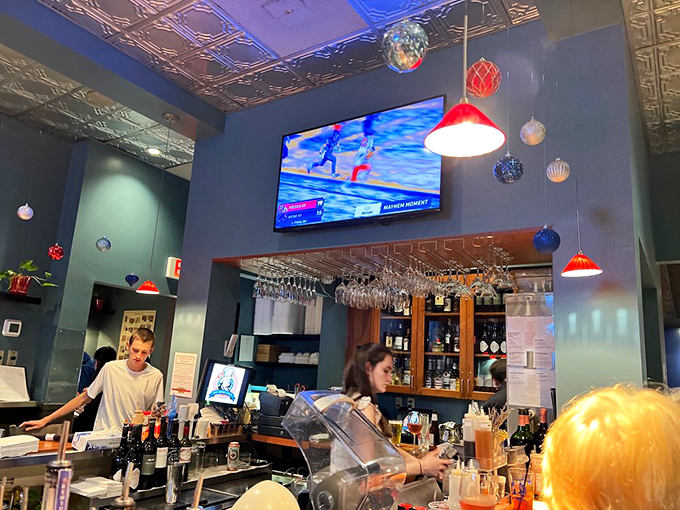 Behind the bar, where liquid philosophy is crafted with the same care as the food. Those hanging glasses are waiting for their moment to shine.