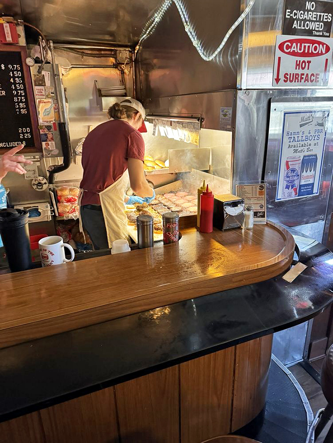 The sacred ritual unfolds&mdash;patties pressed, cheese sealed inside, and magic happening on a grill seasoned by decades of use.