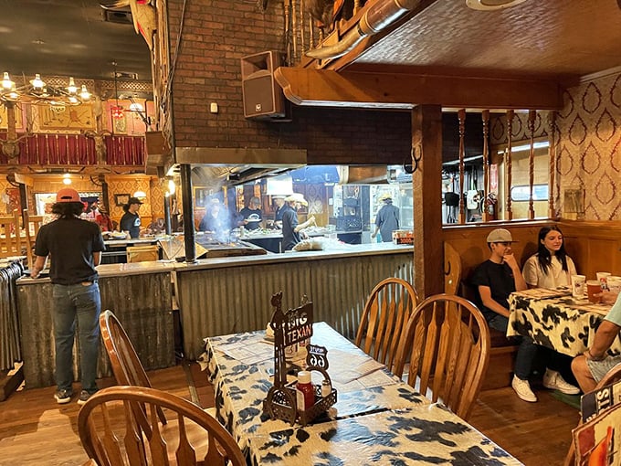 The open kitchen design lets you watch the culinary cowboys work their magic—turning raw ingredients into Texas-sized legends.