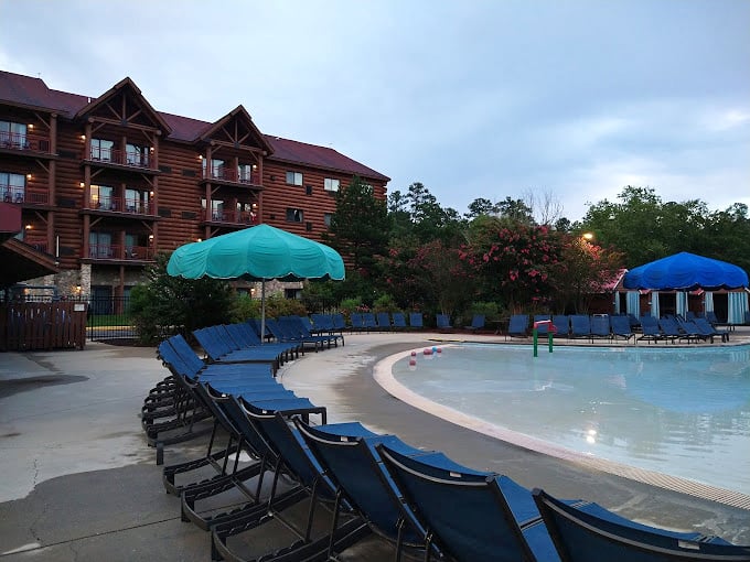 The outdoor pool area at dusk, where the day winds down but nobody's quite ready to admit the fun should end just because the sun decided to clock out.