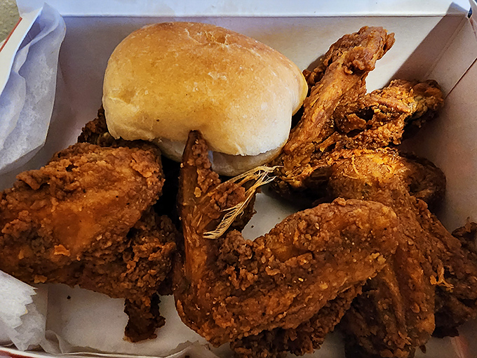 A beautiful box of crispy wings accompanied by their perfect companion&mdash;a fresh roll ready for action.