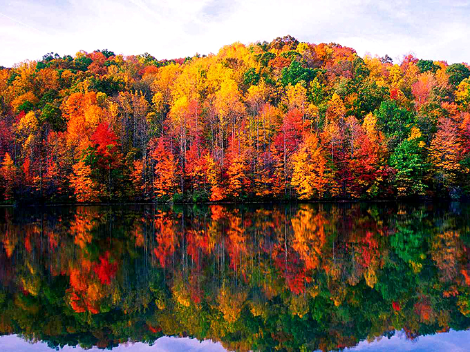 Fall foliage reflected in still waters creates nature's perfect mirror image. The explosion of autumn colors makes even the most jaded traveler stop and reach for their camera.
