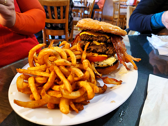 A burger that requires jaw exercises before attempting. Those curly fries aren't sides&mdash;they're supporting actors deserving their own Academy Award.