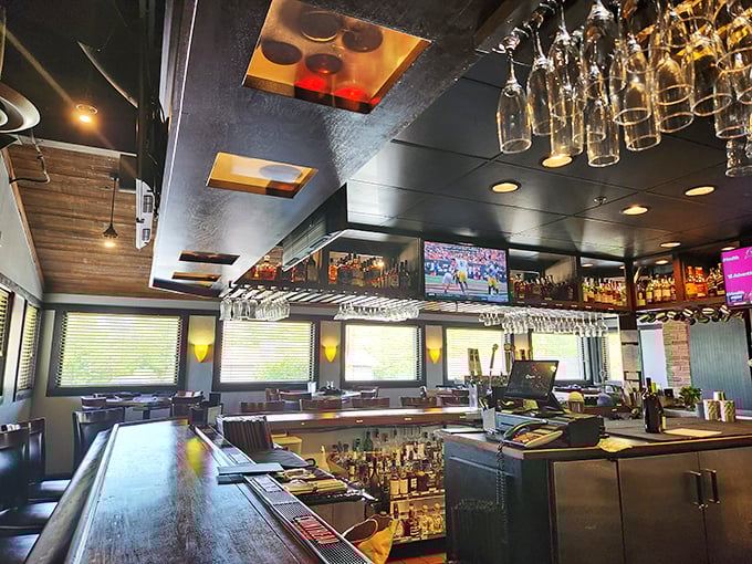 The bar at BakerStreet isn't just where drinks are made; it's command central for an evening of sophisticated indulgence. Those hanging glasses await their moment of purpose.