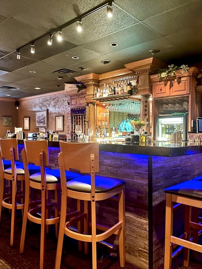 The bar area glows blue like a sophisticated grotto. Where wine flows, conversations grow, and pasta dreams come true.