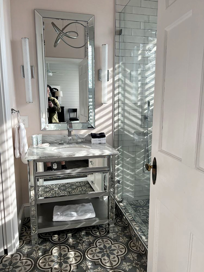 Even the bathrooms blend historical charm with modern necessities, featuring patterned tile floors that Instagram influencers would travel miles to photograph.