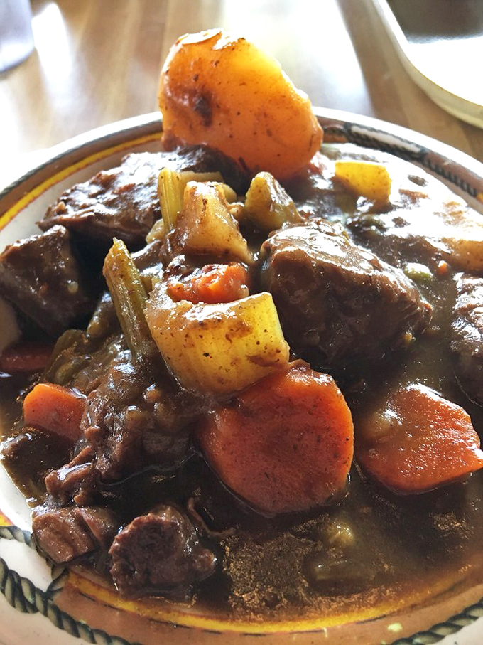 This isn't just stew; it's a slow-simmered masterpiece where beef surrenders completely to its vegetable companions. Comfort in a bowl, no passport required.