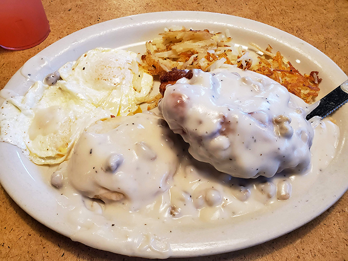 Biscuits and gravy with eggs and hash browns &ndash; a plate that says "good morning" with more conviction than your three alarm clocks combined.