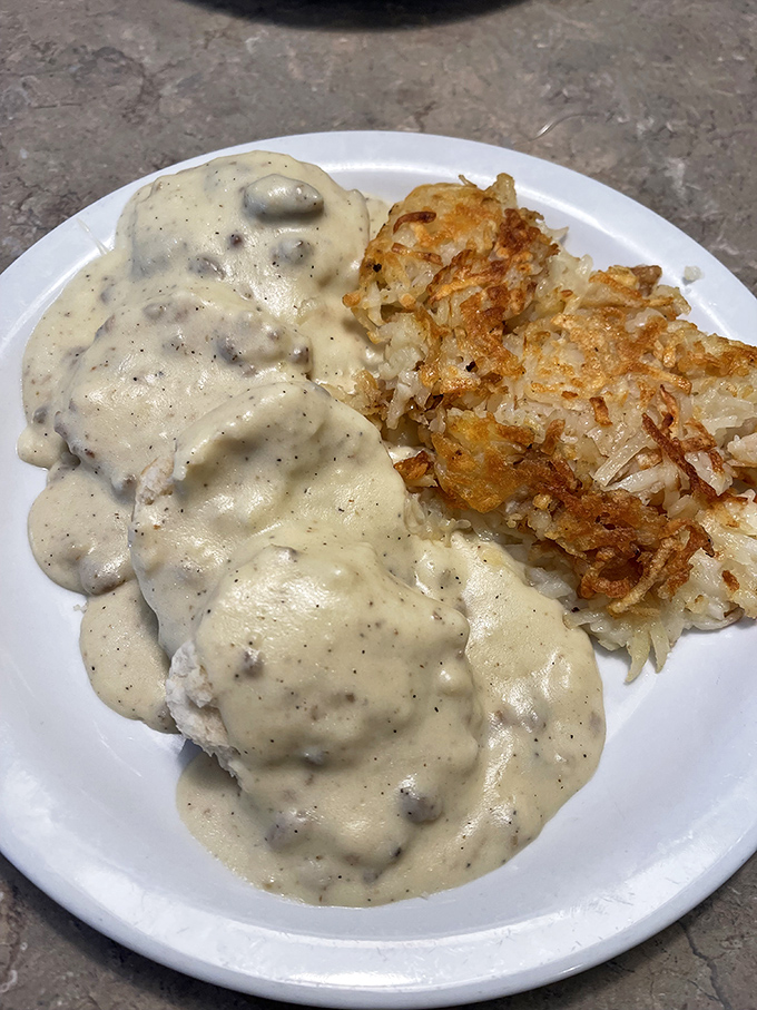 Biscuits and gravy &ndash; the Southern breakfast equivalent of a warm embrace, executed with creamy, peppery perfection alongside golden hash browns.